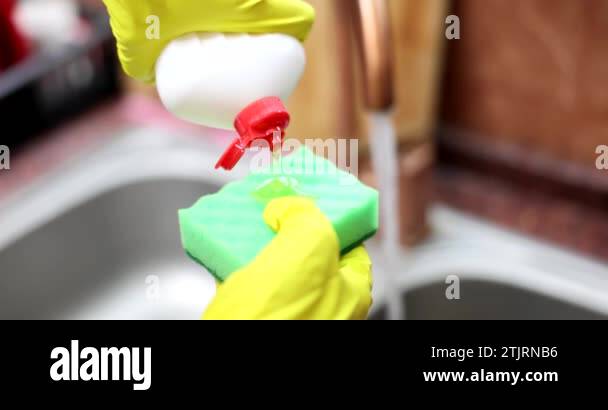 Housewife pouring detergent on sponge from bottle closeup 4k movie slow ...