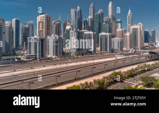 Dubai marina tallest block of skyscrapers timelapse with shadows moving ...