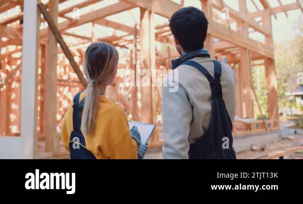 two architects look at buildings, one of them shows up of forefinger ...