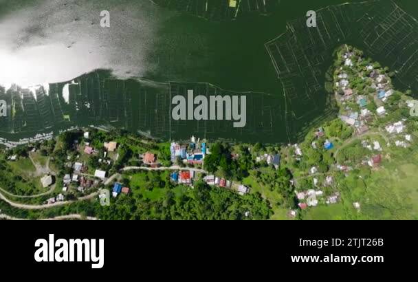 Top down view of Lake Sebu with sunlight reflection on water with fish ...