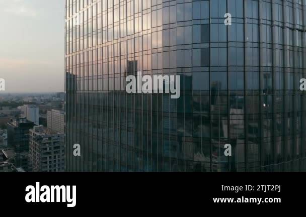 Reveal of the dusk sky and the city reflection on the high rise ...