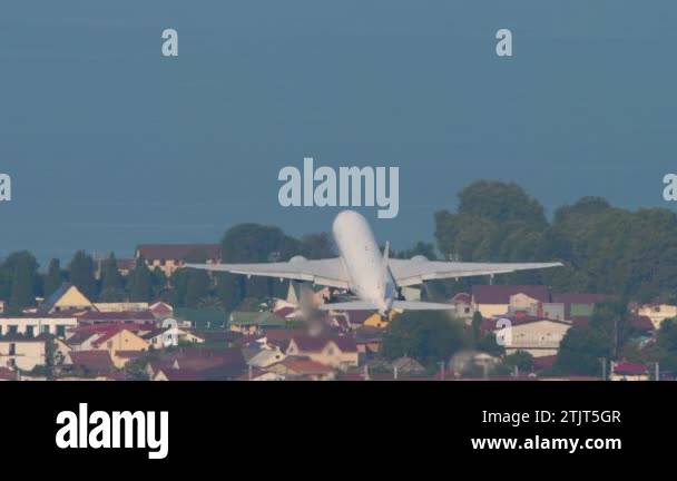 Widebody passenger airplane climb after takeoff, fly away, long shot ...