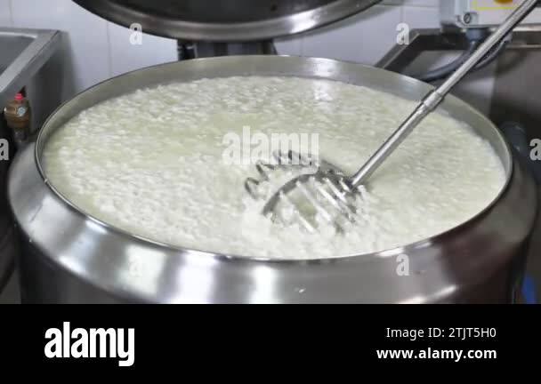 Making cheese from fresh milk at a private cheese factory. The process ...