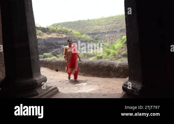 Woman tourist visit to the Ajanta caves and exploring the ancient ...