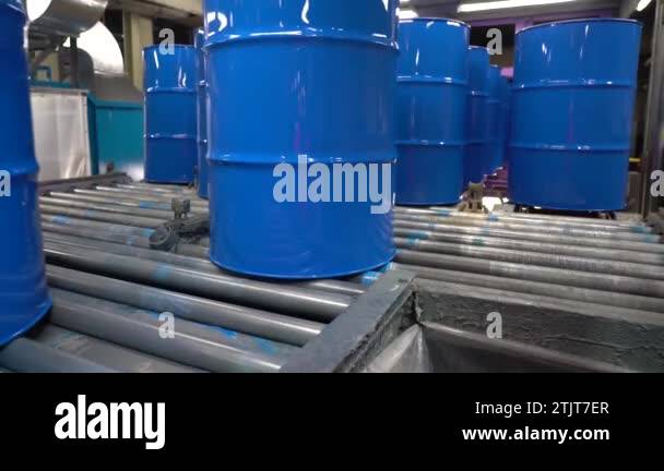 Machine oil production plant. Metal barrel with engine oil. Conveyor ...