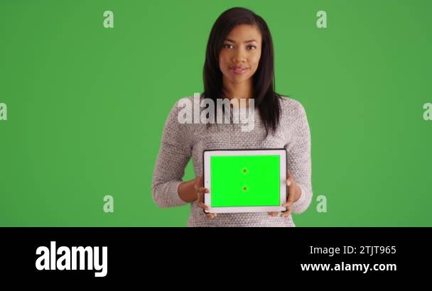 Portrait of happy black woman holding tablet with green screen for ...