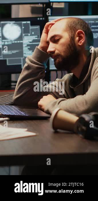 Vertical video: App IT engineer sleeping on desk and being drained ... Vertical video: App IT engineer sleeping on desk and being drained ...