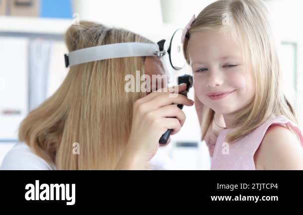 Otolaryngologist conducts physical examination of little girl ear ...