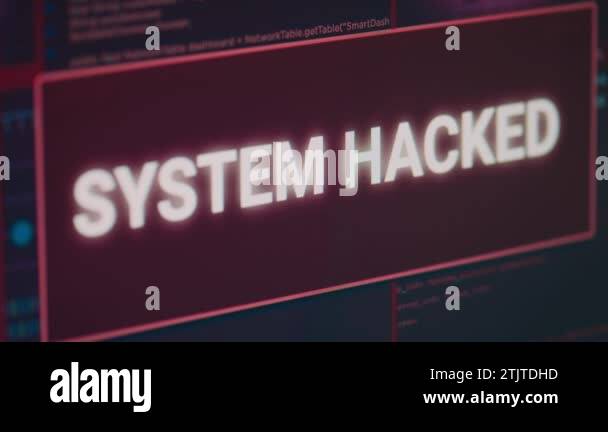 Hacked system alert message flashing on computer screen, showing ...
