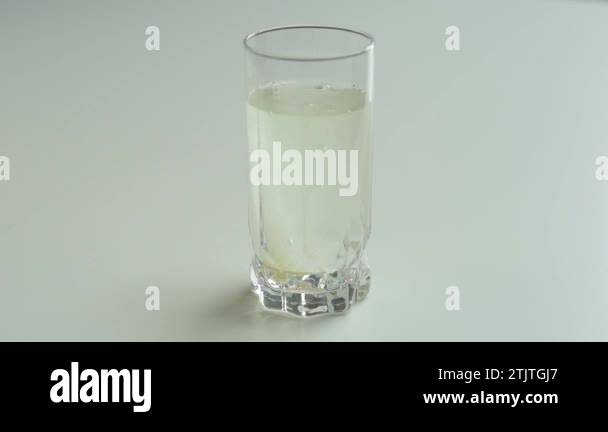 The tablet dissolves in a glass of water. The hiss of a soluble ...