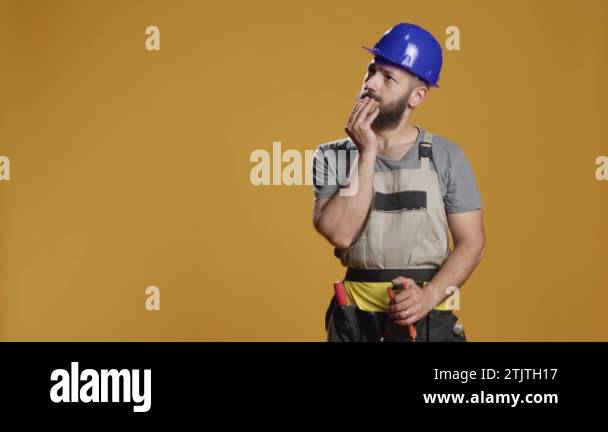 Construction worker brainstorming ideas to work on rebuilding, thinking ...