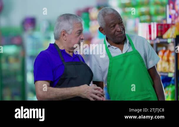 Senior diverse employees of grocery store discussing management of ...