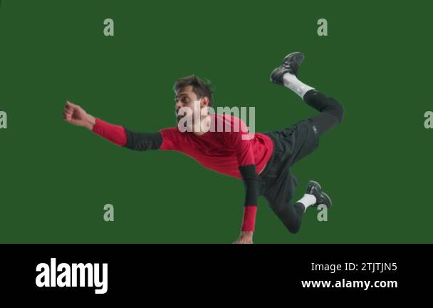 Young man bouncing, falling and batting ball. Athlete playing ...