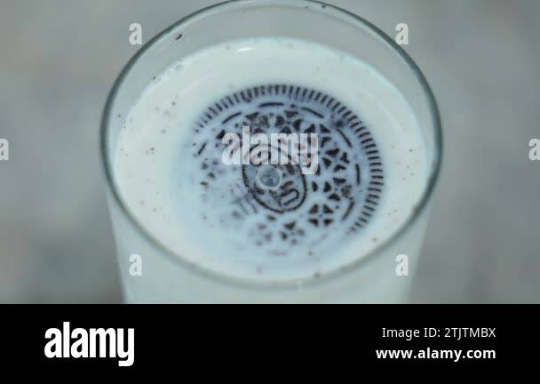 Milk with cookies. Chocolate chip cookies float in milk. Oreo with milk ...