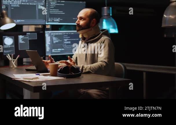 Database admin with neck collar foam working on code developing at ... Database admin with neck collar foam working on code developing at ...