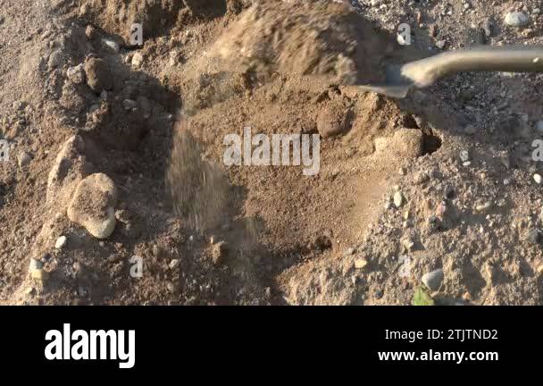 Builder digging gravel Stock Video Footage - Alamy