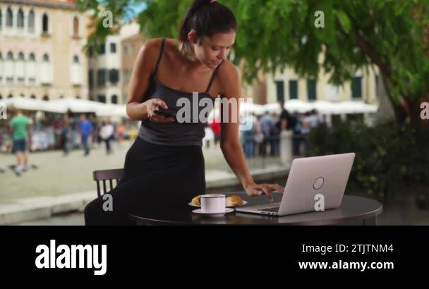 Pretty business woman in Italy multitasking texting and working on ...