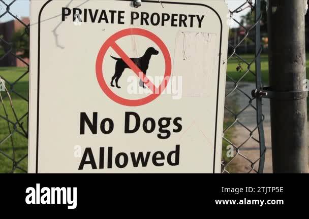 frame left private property no dogs allowed sign in black writing on ...