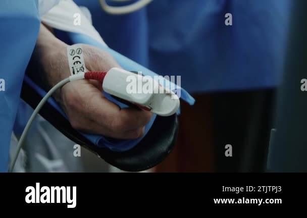 Medical equipment connected to the patient's arm to measure oxygen ...