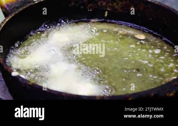 Close-up of the hands of the cook putting the dough into the boiling ...
