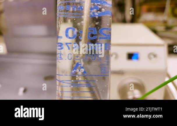 Nitrogen bubble through organic solvent in measuring cylinder in a ...