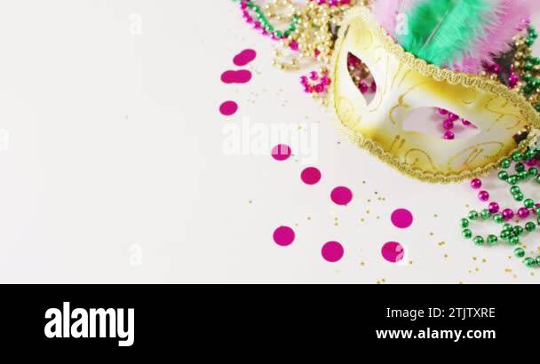 Video of masquerade mask, mardi gras beads and confetti on white ...