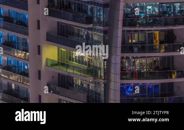 Night view of exterior apartment colorful building timelapse. High rise ...