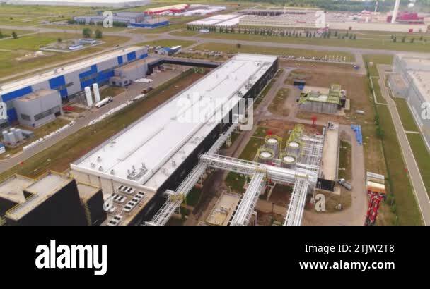 Huge metal tanks connected to production tower with pipelines at ...