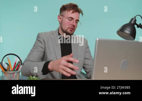 Dislike. Upset bearded business man sitting at office desk showing ...