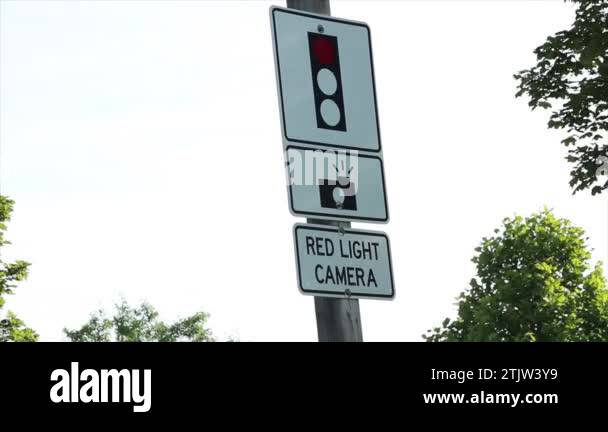 red light camera sign with picture of camera flashing and red traffic ...