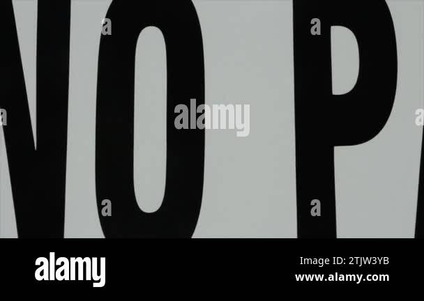 pan right on sign caption that says no parking, really large in frame ...