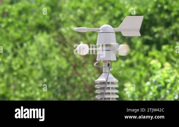 Weather vane and wind sensor of a weather station moving by the action ...