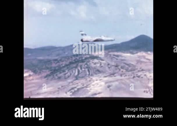 Grey combat airplane in flight over American mountains. Side view from ...