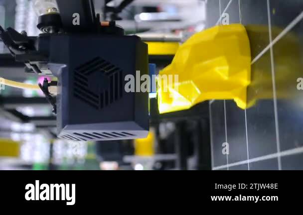 3D printer printing prototype toy from molten plastic. Process creating ...