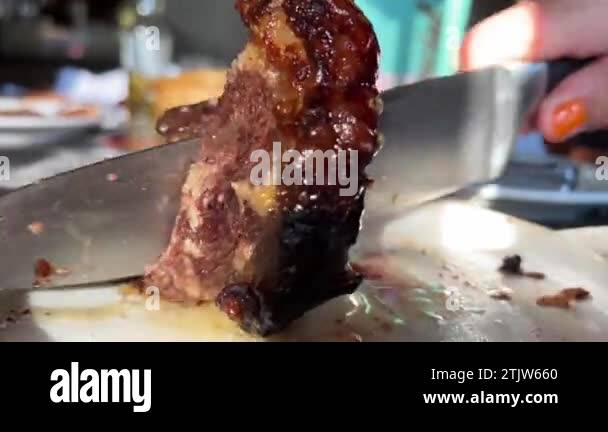 Appetizing grilled pork cooked on the spit. Roasted leg of pork on ...