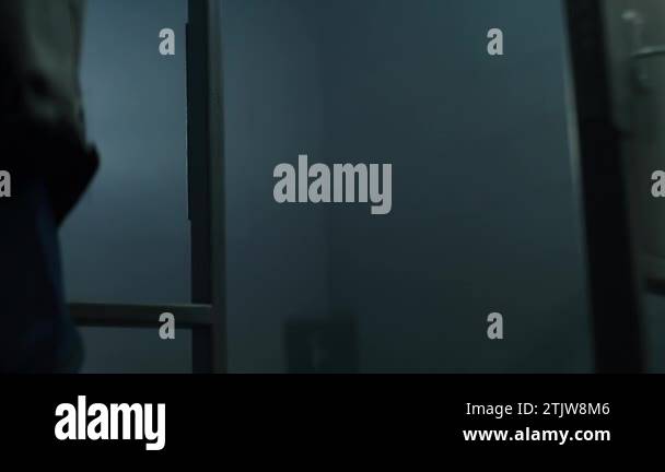 Close up of prison employee opening and locking jail cell with keys ...