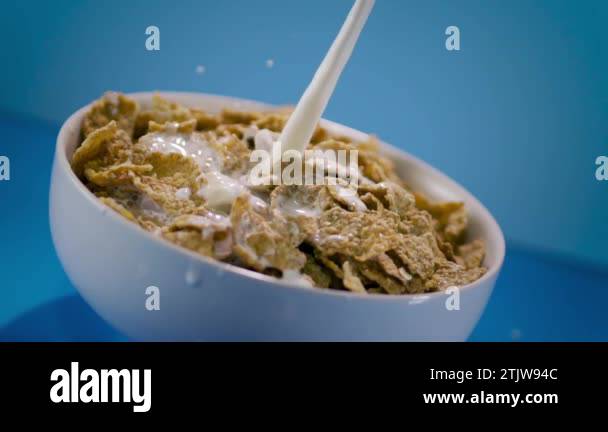 Pouring Milk in Corn Flakes Cereal Stock Video Footage - Alamy