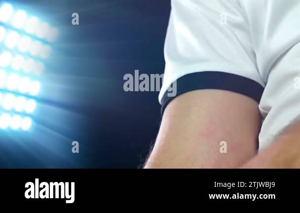 Football, soccer game. Professional footballer in white outfit putting ...