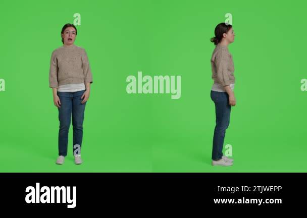 Angry displeased woman standing on full body green screen, showing ...