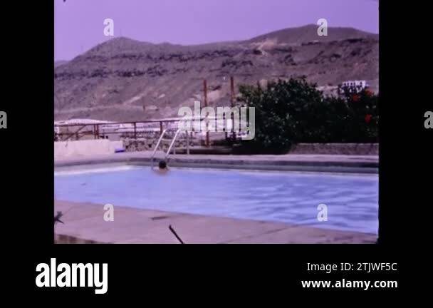 Gran Canaria, Spain June 1974: Child dives and swims in the pool scene ...