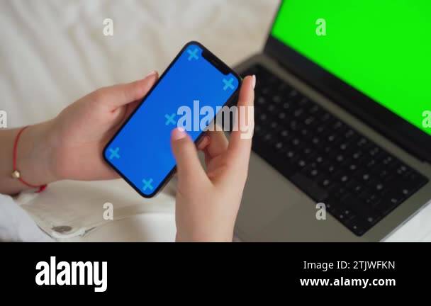 Close up teenage hands using smartphone green blue screen Chroma Key. Child girl scrolling over ...
