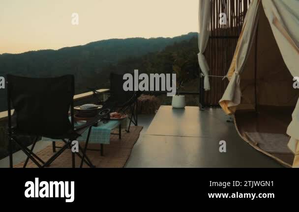 Modern resort with comfortable tent, terrace, folding camp chairs and ...