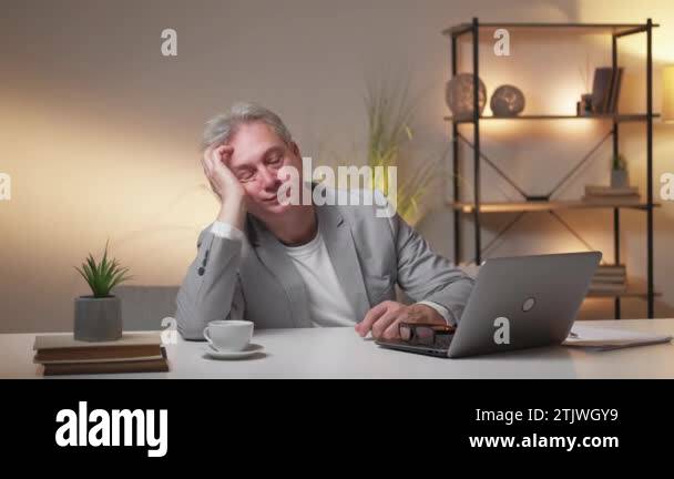 Late work. Sleepy aged man. Digital connection. Exhausted male napping ...