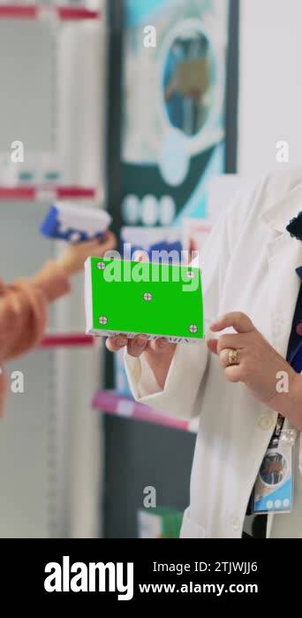Vertical video: Woman pharmacist holding box of pills with greenscreen ...