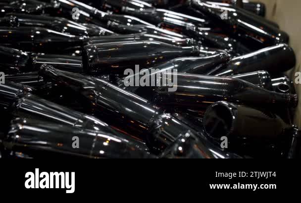 Heap of bottles stacked at glass recycling factory. From above pile of ...