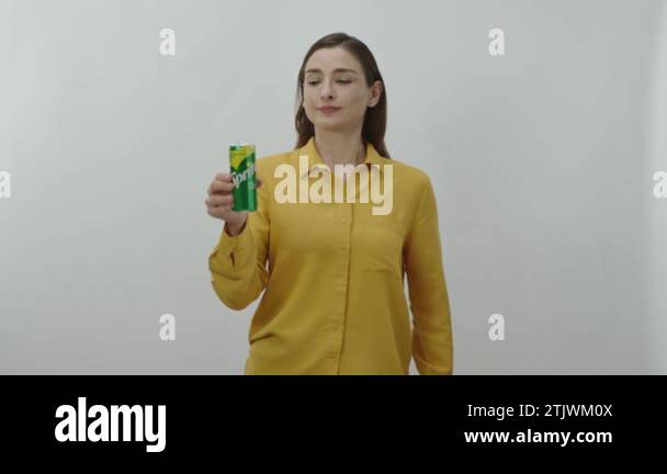 Character portrait of a young woman drinking Sprite from a tin can ...