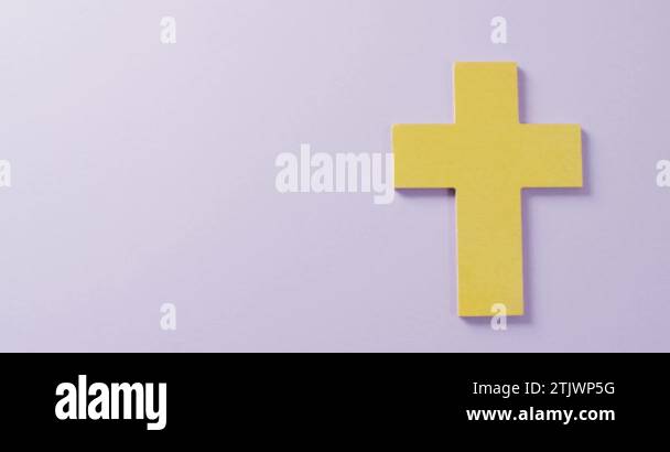 Video of yellow christian crucifix cross symbol on lilac background ...