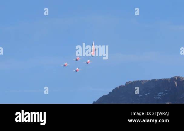Fighter jets in red white colors of Swiss flag cross in flight on blue ...