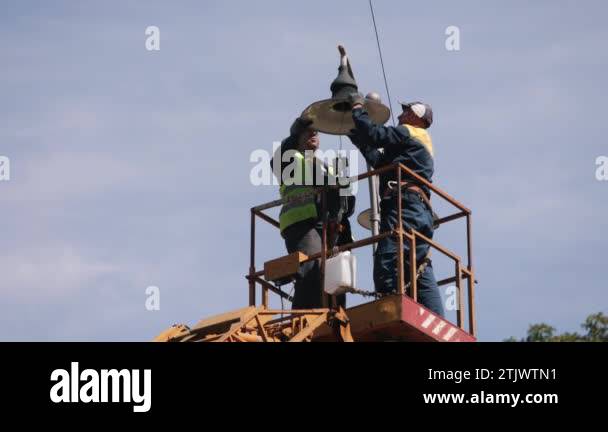 diode lights, pole lamp, Municipal worker. Workmen working on repairing ...