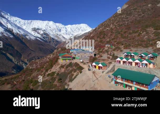 Hotel and lodges in high mountain landscape. Sunny day in Himalayas ...